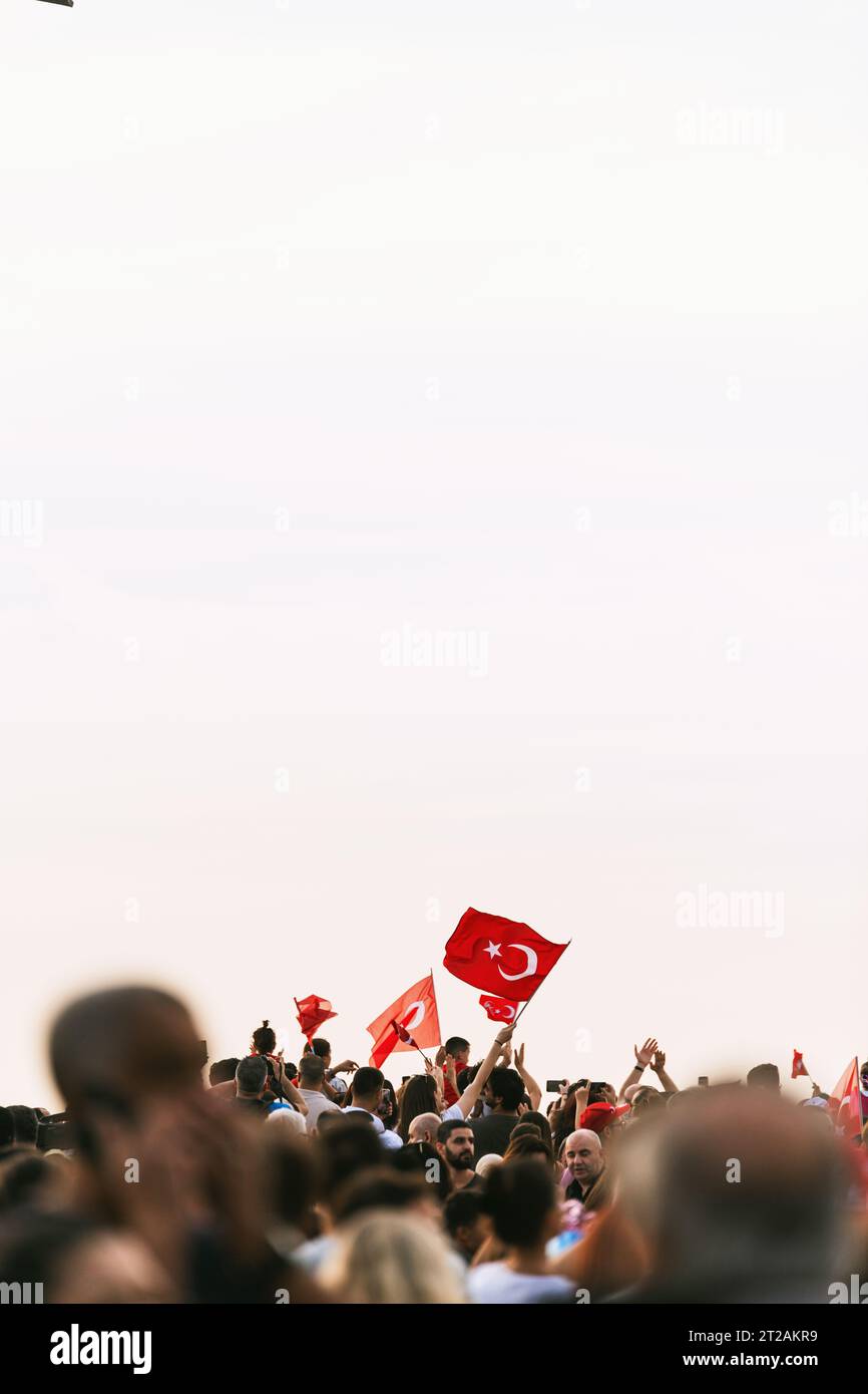 Izmir, Turkey - September 9, 2023: A jubilant crowd waves multiple ...