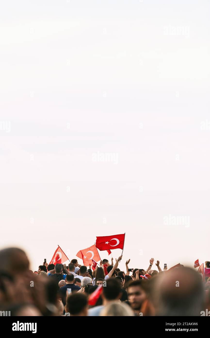 Izmir, Turkey - September 9, 2023: A jubilant crowd waves multiple ...