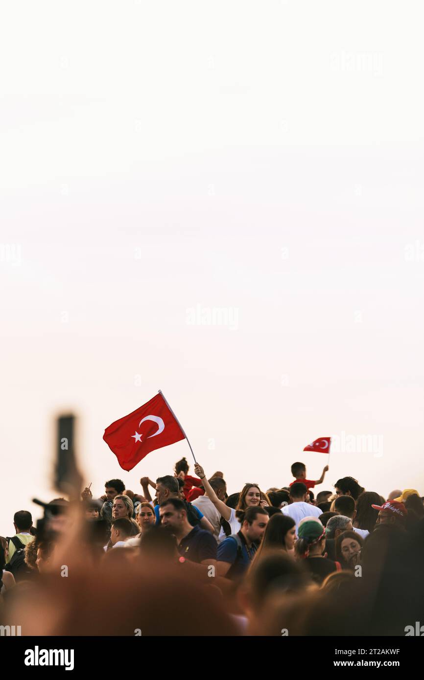 Izmir, Turkey - September 9, 2023: A jubilant crowd waves multiple ...