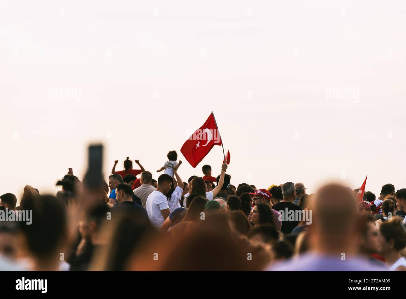 Izmir, Turkey - September 9, 2023: A jubilant crowd waves multiple ...