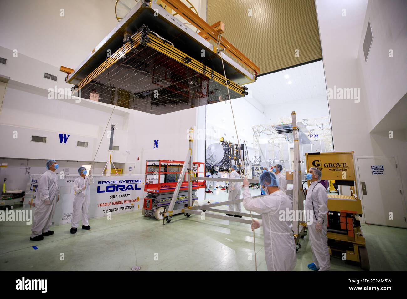 Psyche Solar Array Unboxing. A NASA team assists as a crane is used to ...