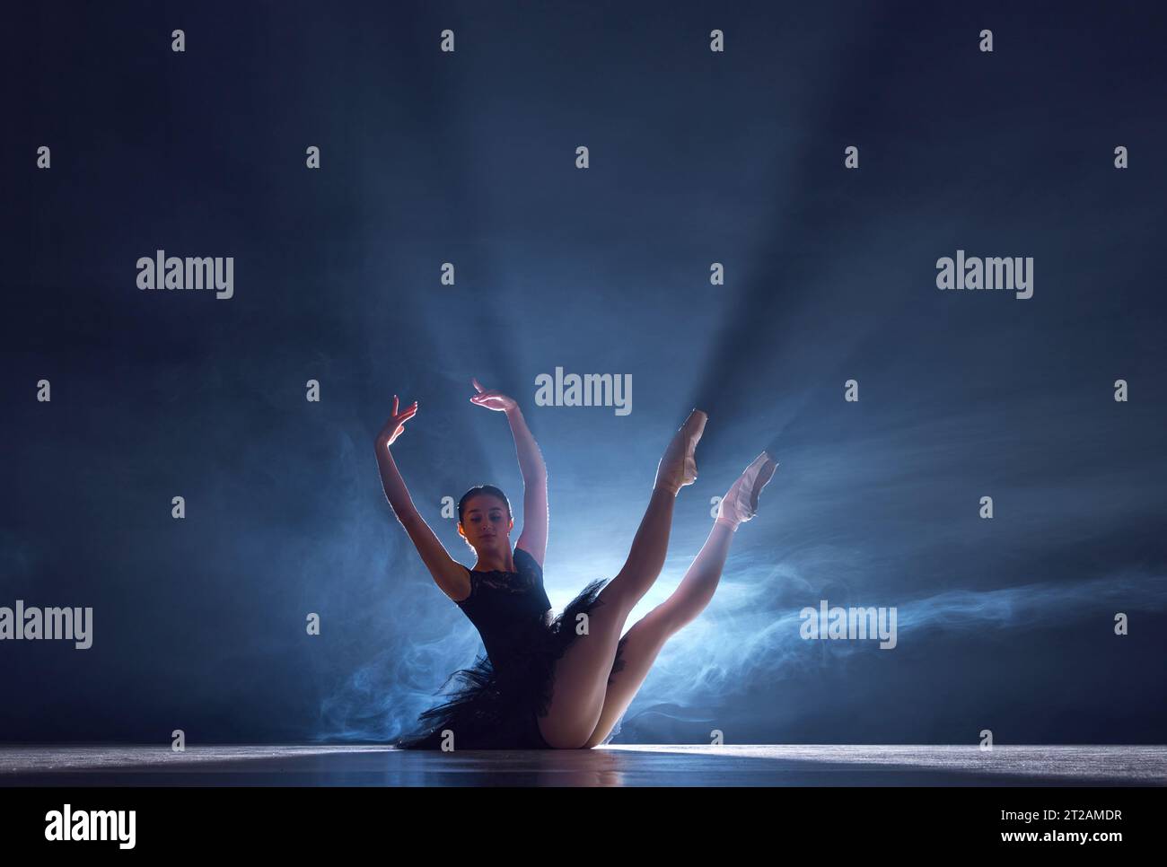 Elegance and grace in movements. Beautiful ballerina dancing over blue ...