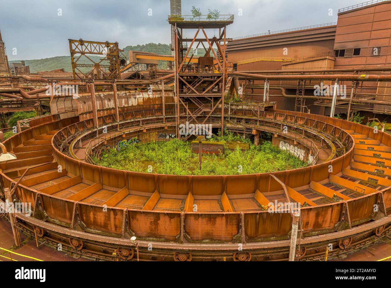 An old fashioned iron mill constructed from rust sits atop weathered ...
