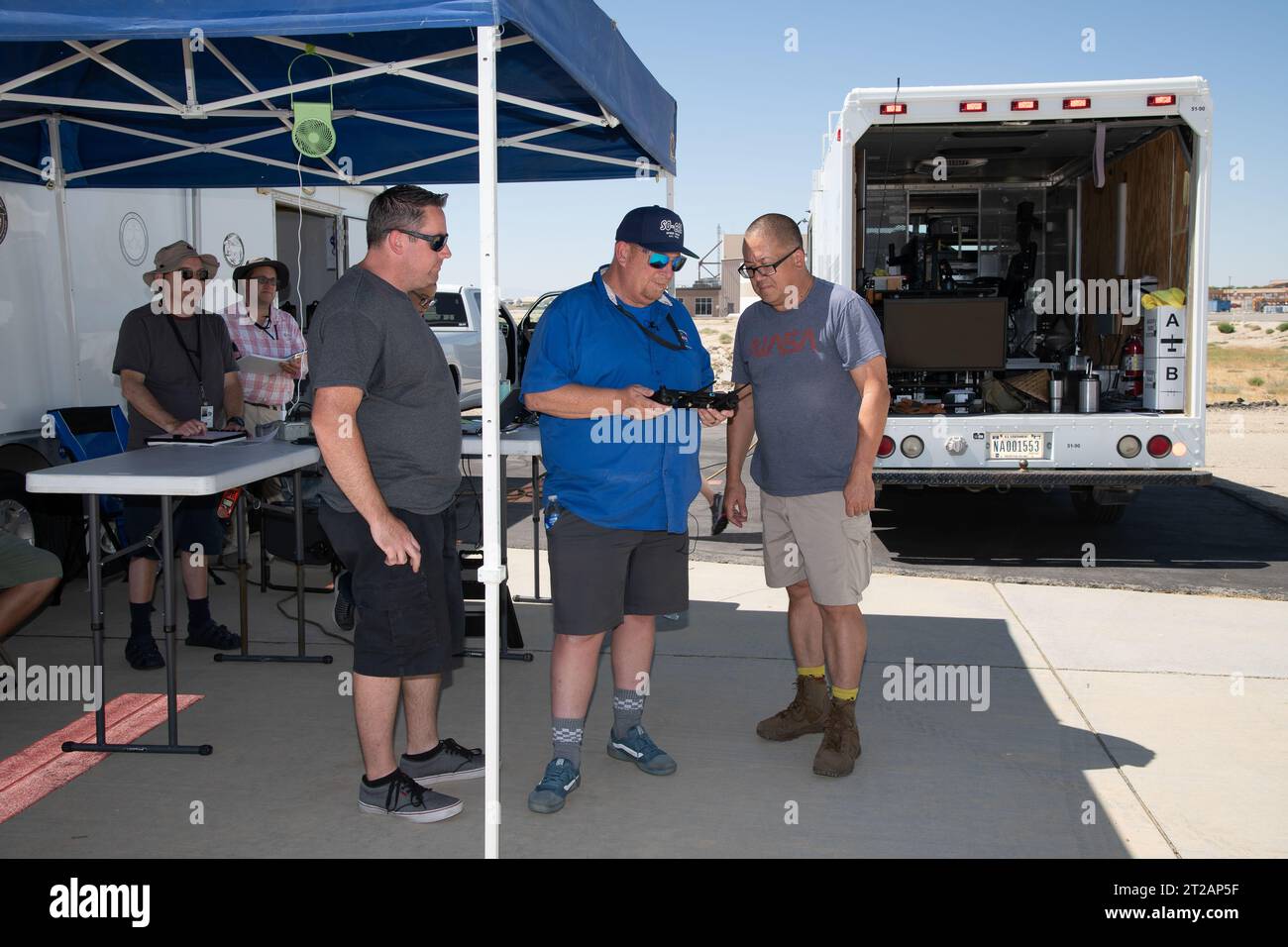 Justin Link, Red Jensen, and Derek Abramson prepare the Alta-X aircraft ...
