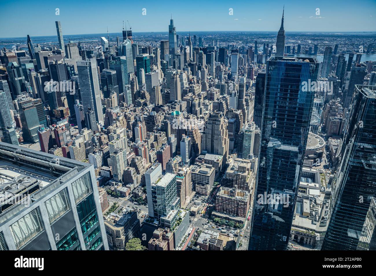 An aerial view of the rooftops of buildings and bustling streets of New ...