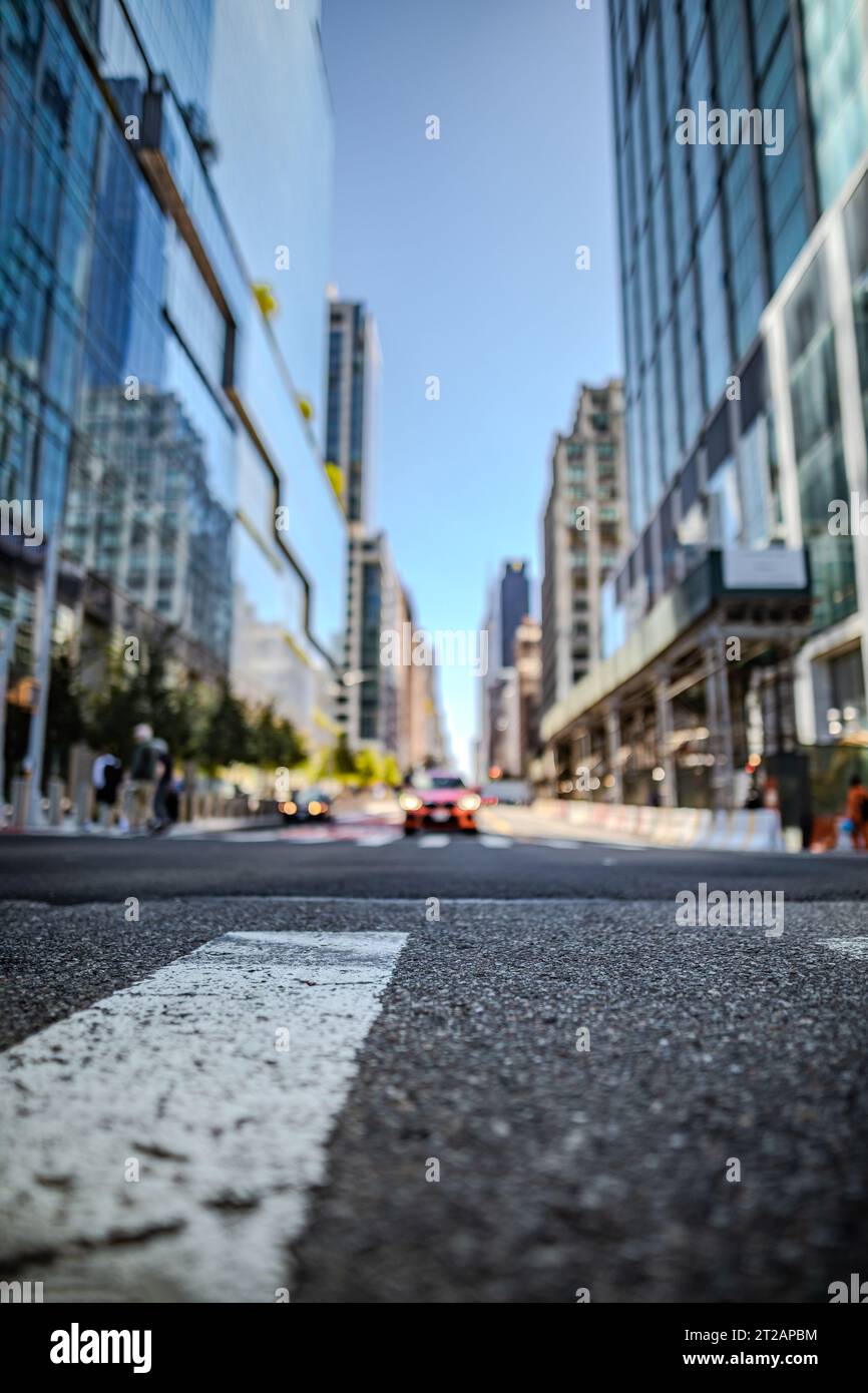 A street with modern office buildings in New York, a car stopped at a ...