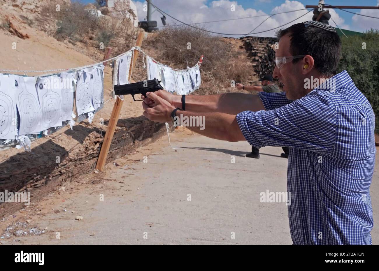 Israeli civilians receive weapons training from a tutor at the shooting ...