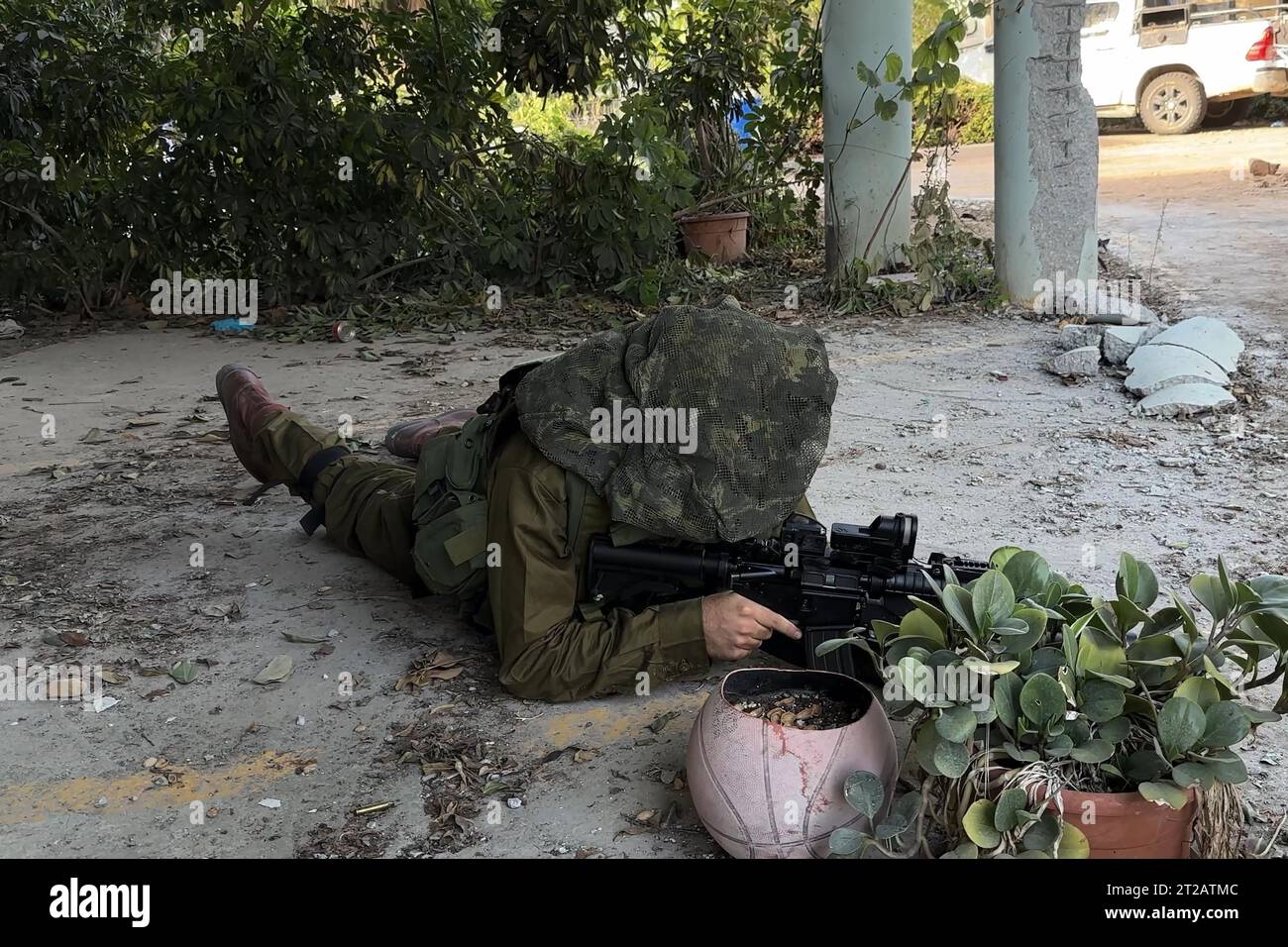 An Israeli soldier takes cover during a rocket attack a week after the ...