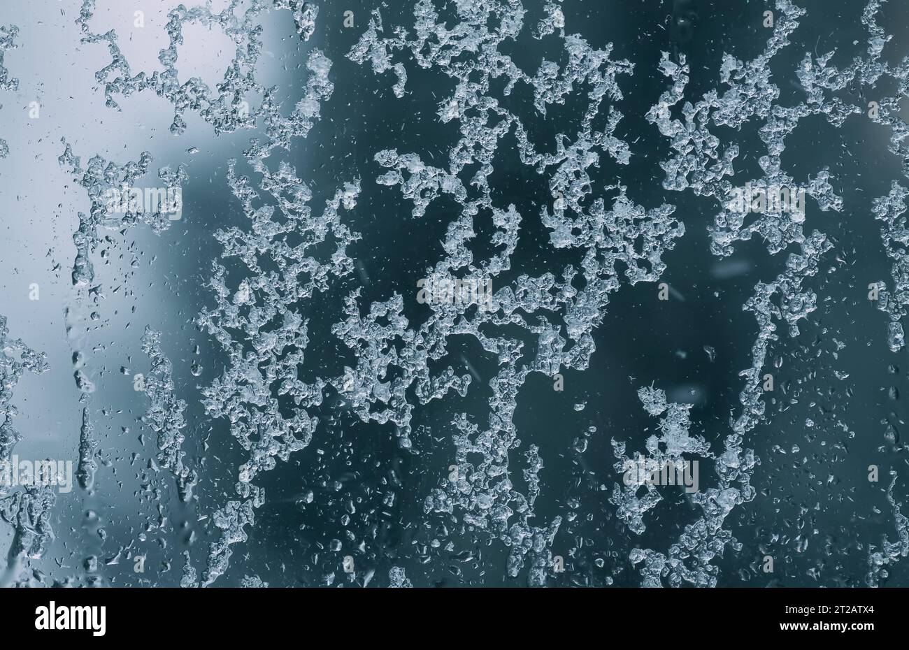 Frozen window glass with melting ice. Wet window background Stock Photo ...