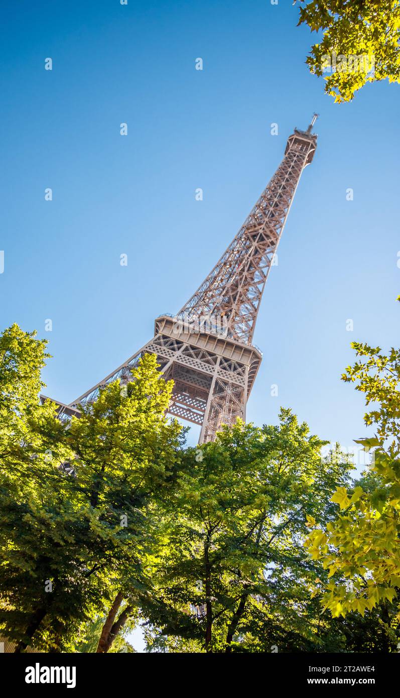 A view of the Eiffel Tower between some Paris city trees and a nice ...