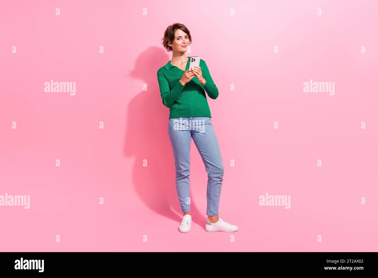 Full body length photo of charming girl influencer using smartphone to ...