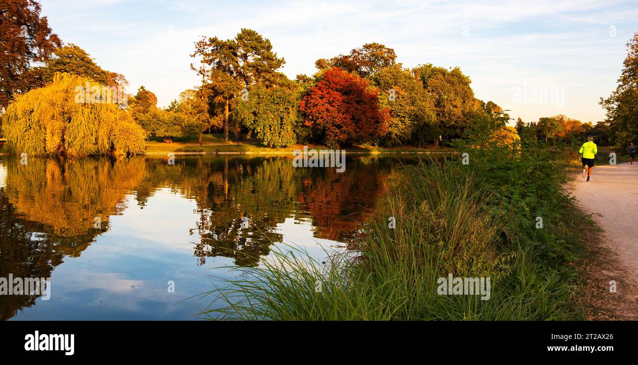 PARIS, FRANCE - OCTOBER 14, 2018: People jogging near Daumesnil lake at ...