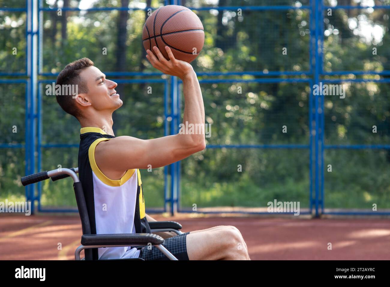 Happy basketball player with disability uses wheelchair while playing ...