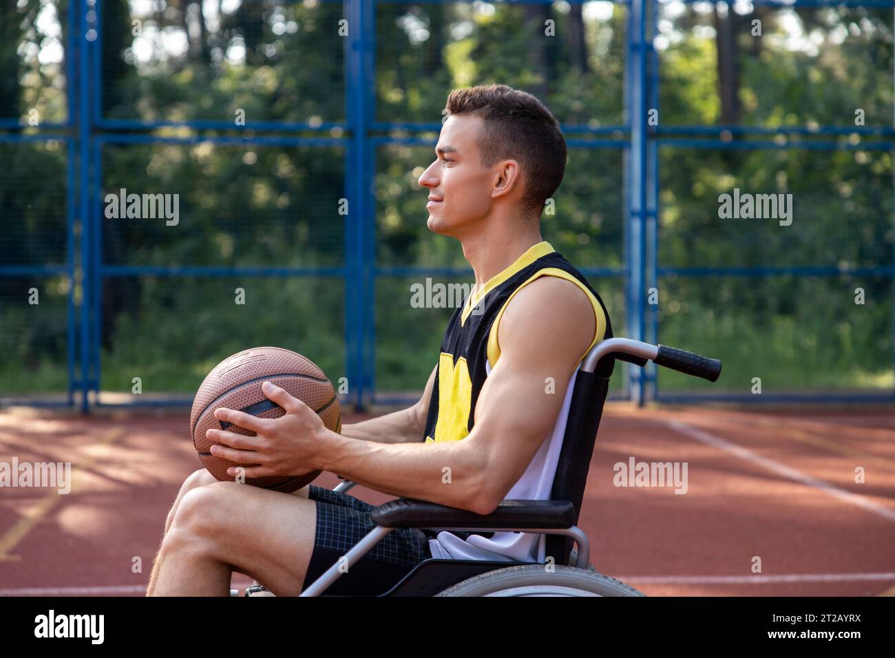 Basketball player man in wheelchair has disability playing on court ...