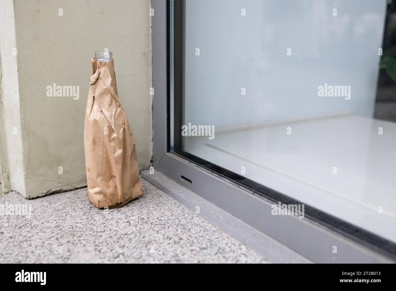 Alcohol bottle wrapped in paper packet Stock Photo - Alamy