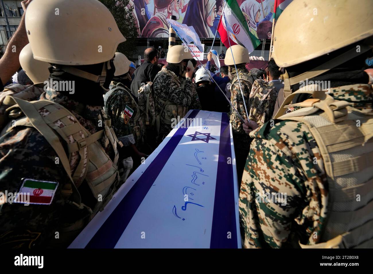 Iranian Basij paramilitary force members carry a symbolic coffin of ...