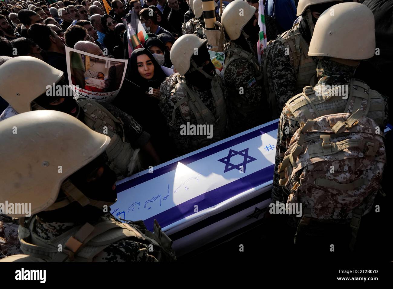 Iranian Basij paramilitary force members carry a symbolic coffin of ...