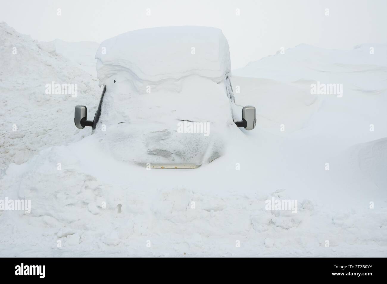 Car under the snow. A lot of snow after a snowfall. The car is ...