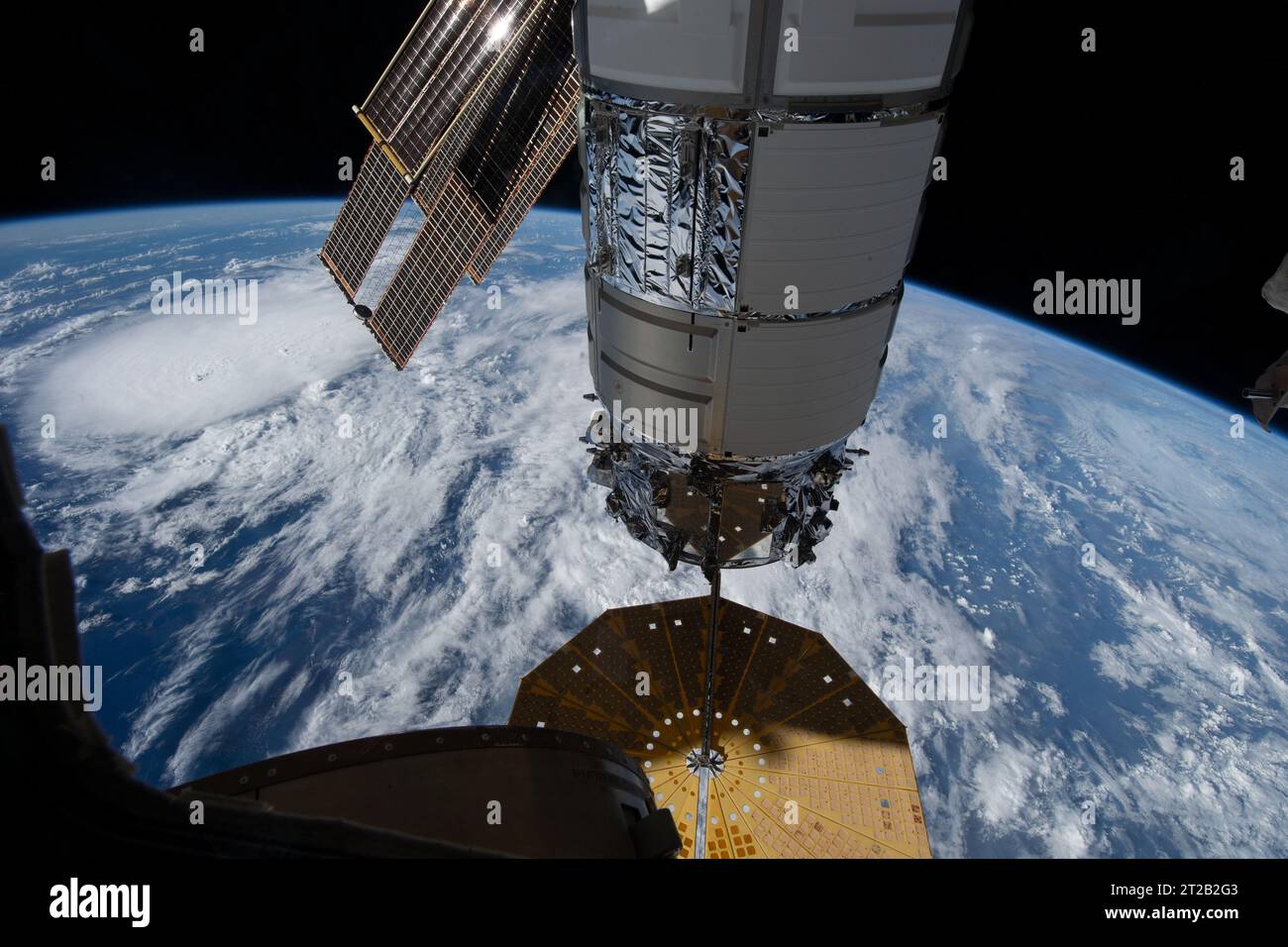 The Cygnus space freighter with an UltraFlex solar array is docked at ...