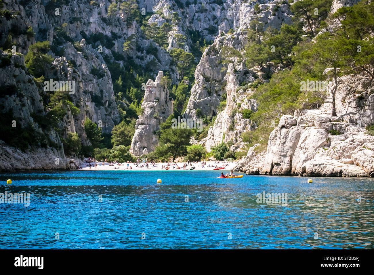 A crowded beach in one of the famous calanques near Cassis, southern ...