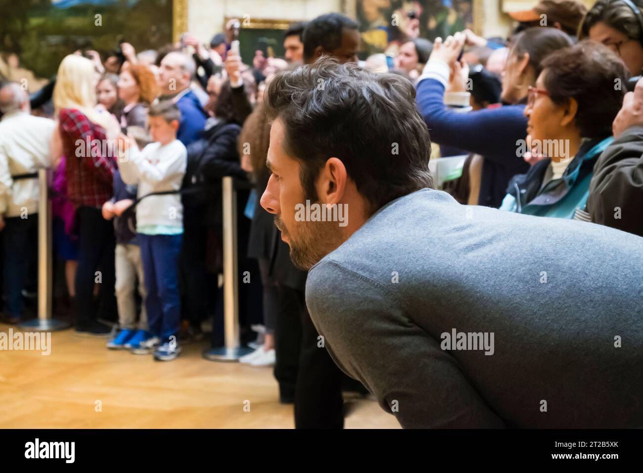 Adult male looks at fine art in the Louvre Museum, Paris, France, with ...