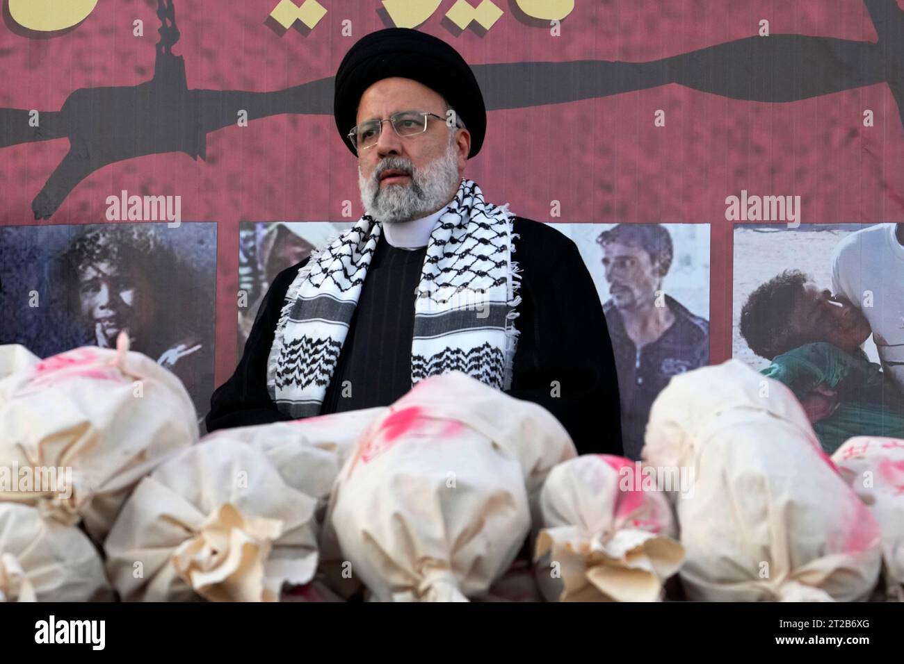 Iranian President Ebrahim Raisi stand before the symbolic shrouded ...