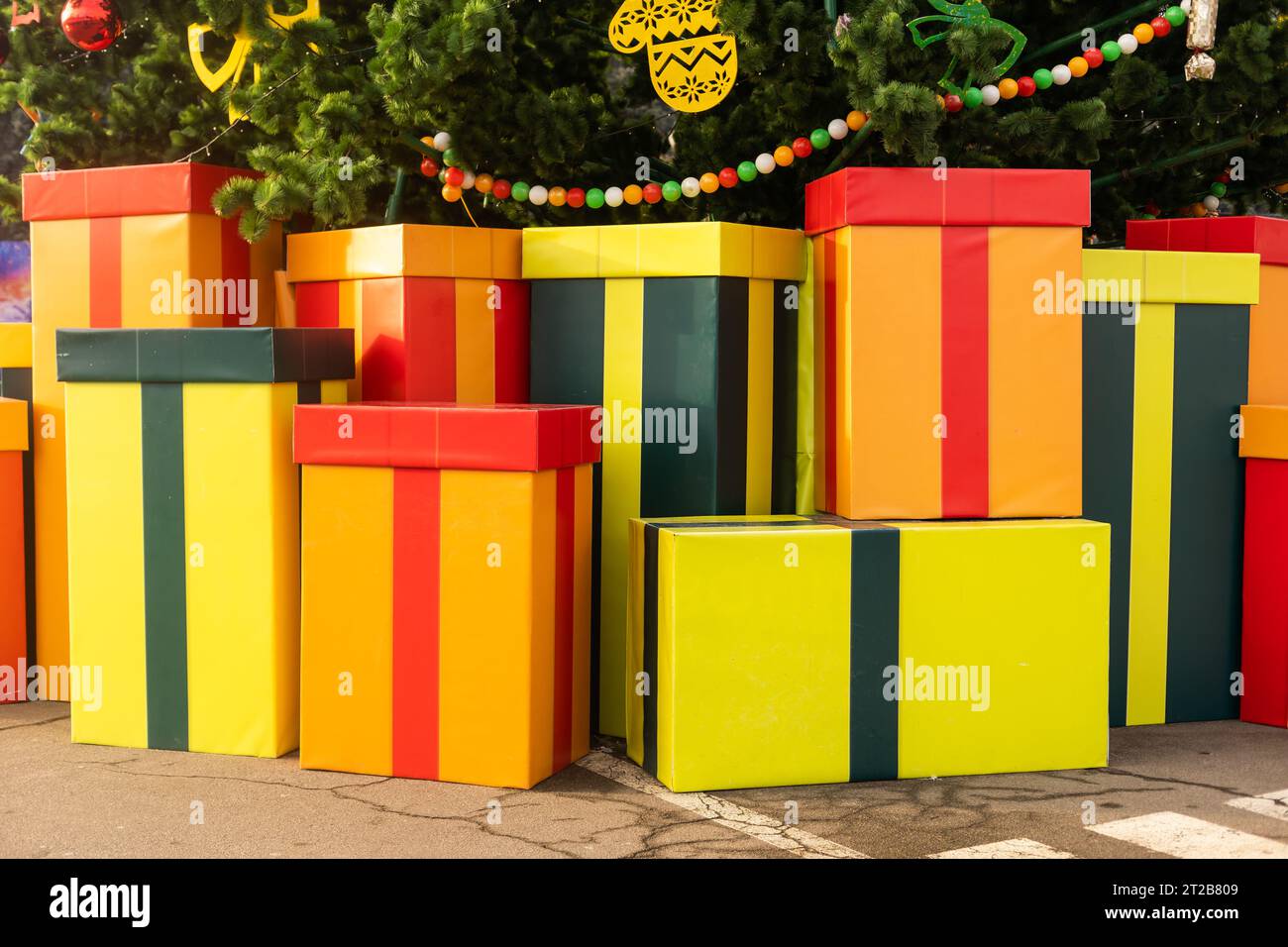 Large gift boxes with bows in the town square. Christmas street decor ...