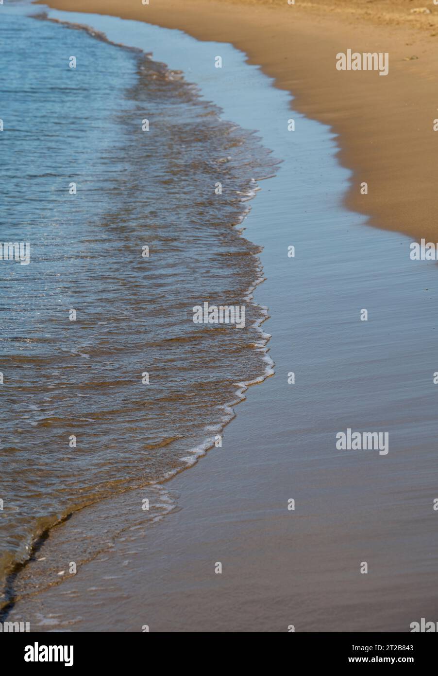 abstract of waves lapping on a beach at the seashore. sandy beach with ...