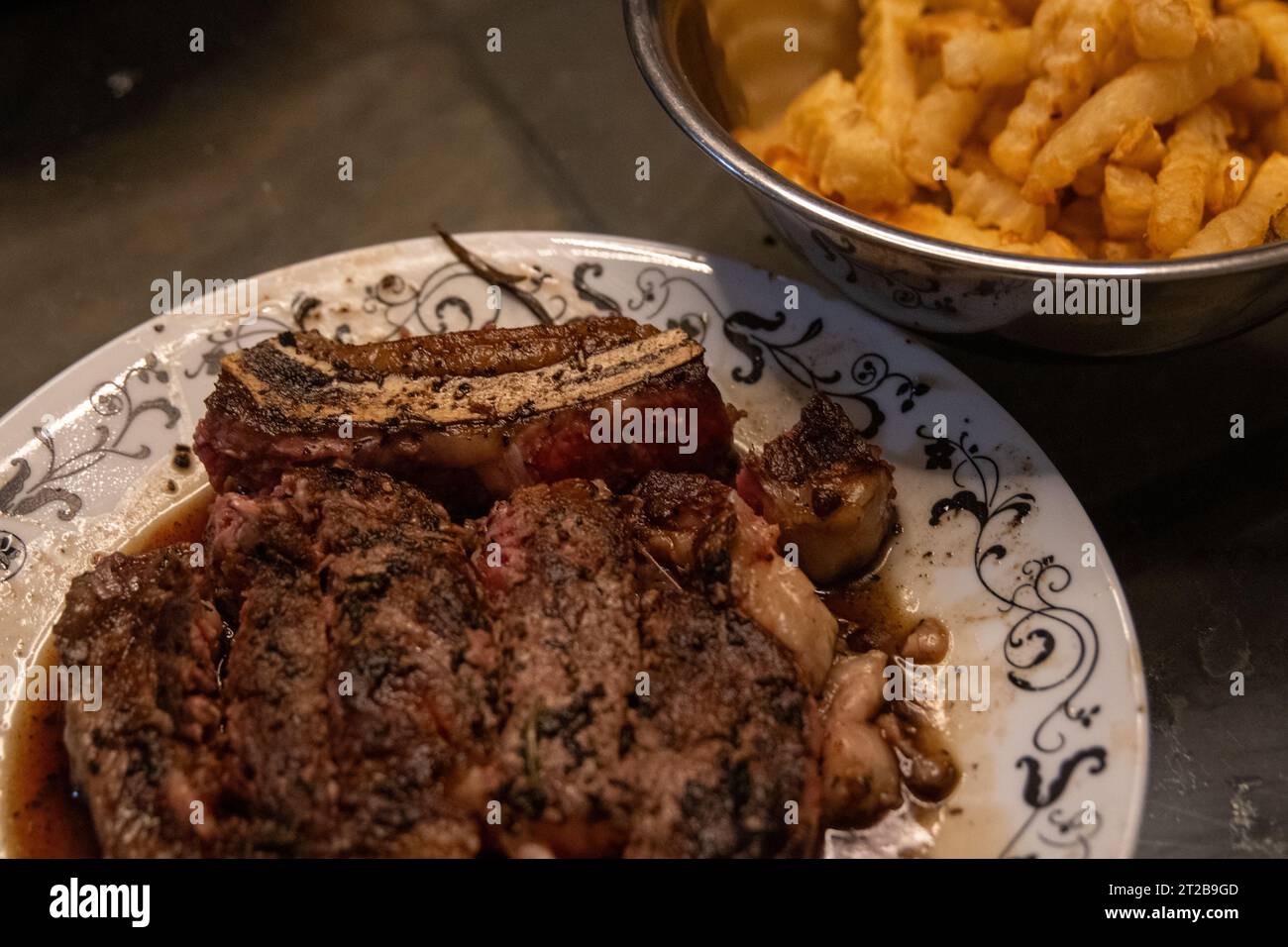 Fatty Bone In Seared Ribeye with fries Stock Photo - Alamy