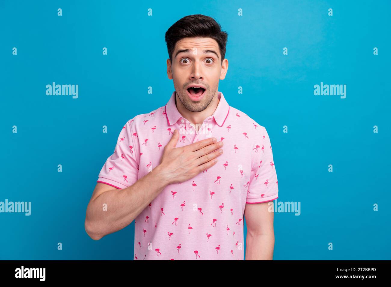 Portrait of impressed speechless young man arm touch chest open mouth ...
