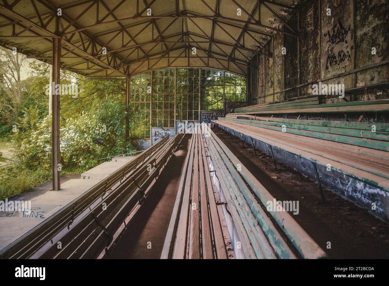 An interior view of a railway station featuring wooden benches and ...
