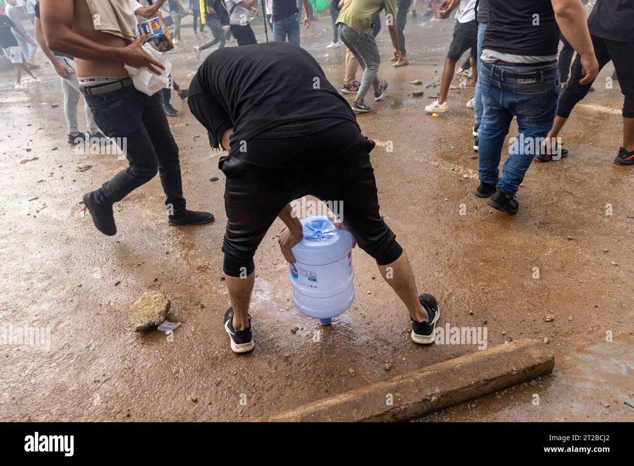 Awkar, Lebanon. 18th Oct, 2023. A demonstrator covers a teargas ...