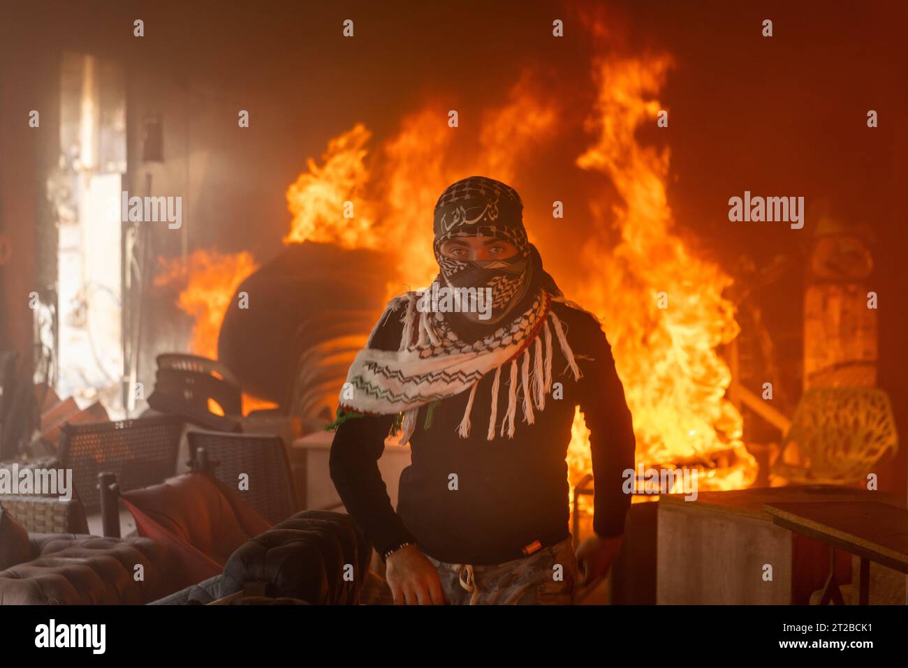 Awkar, Lebanon. 18th Oct, 2023. A demonstrator exits a burning building ...