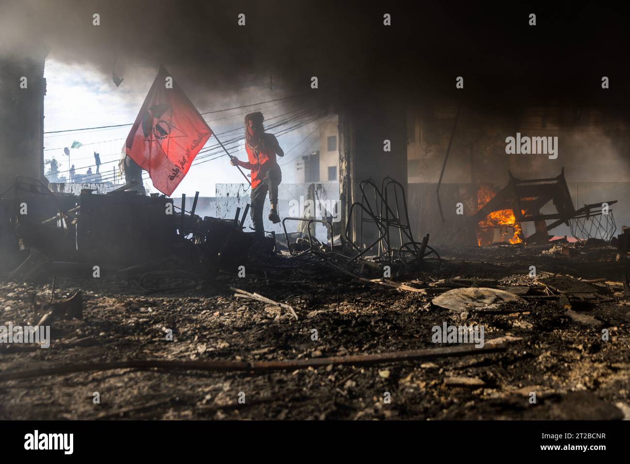 Awkar, Lebanon. 18th Oct, 2023. A demonstrator carries a Popular Front ...
