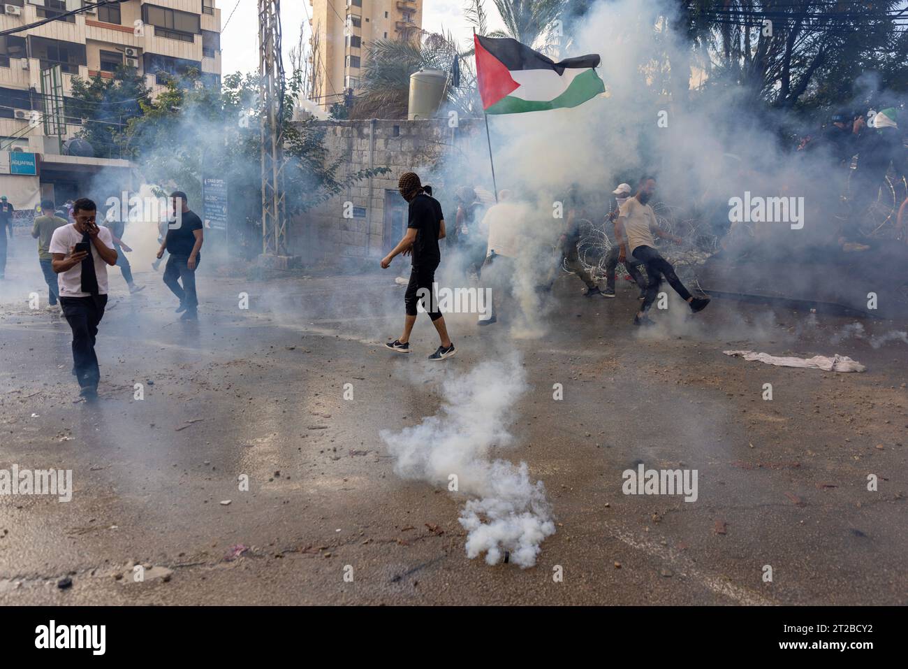 Awkar, Lebanon. 18th Oct, 2023. Demonstrators kicking away teargas ...