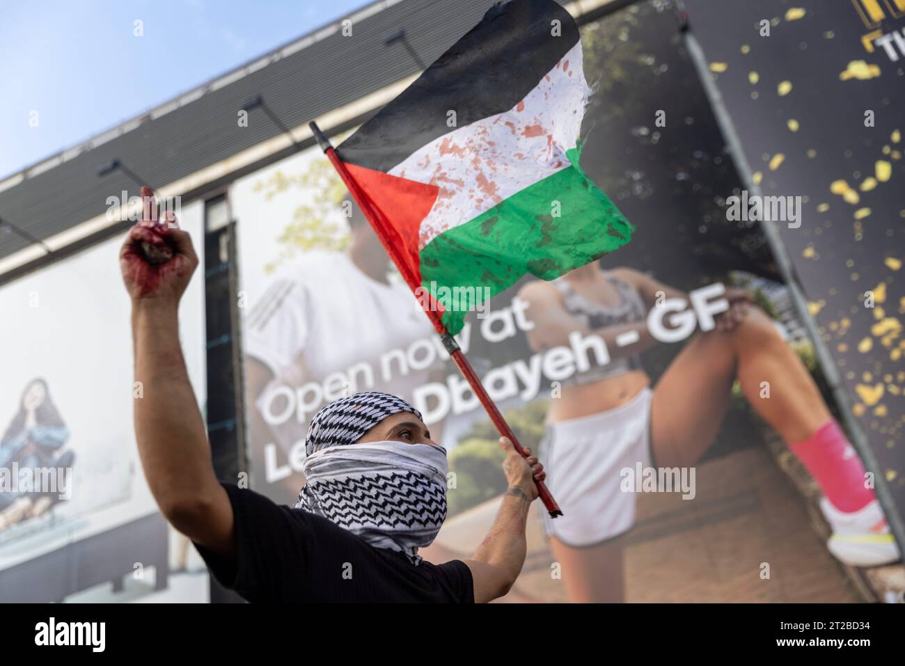 Awkar, Lebanon. 18th Oct, 2023. A demonstrator carries a Palestine flag ...
