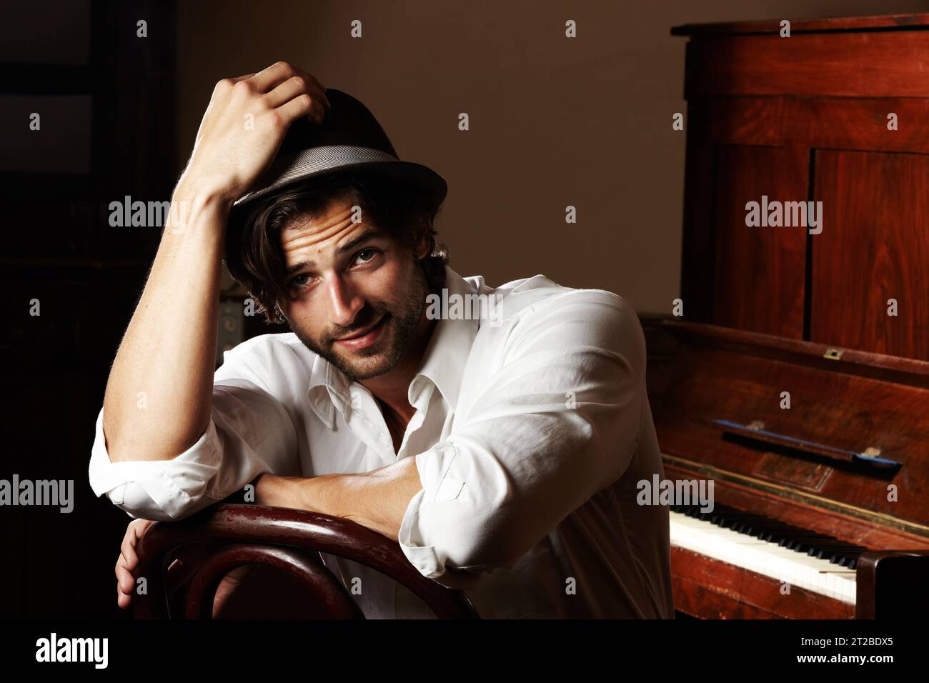 Portrait, musician and man with a piano, creative and fashion with ...