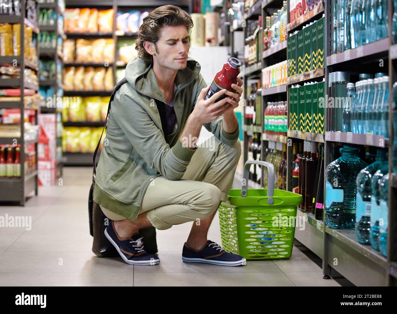 Man, read and label in grocery store or decision, confused or choice ...