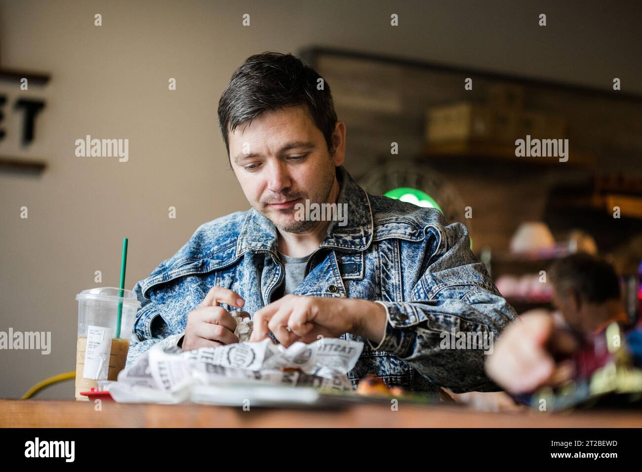Close up of Caucasian handsome man having lunch or supper eating in ...
