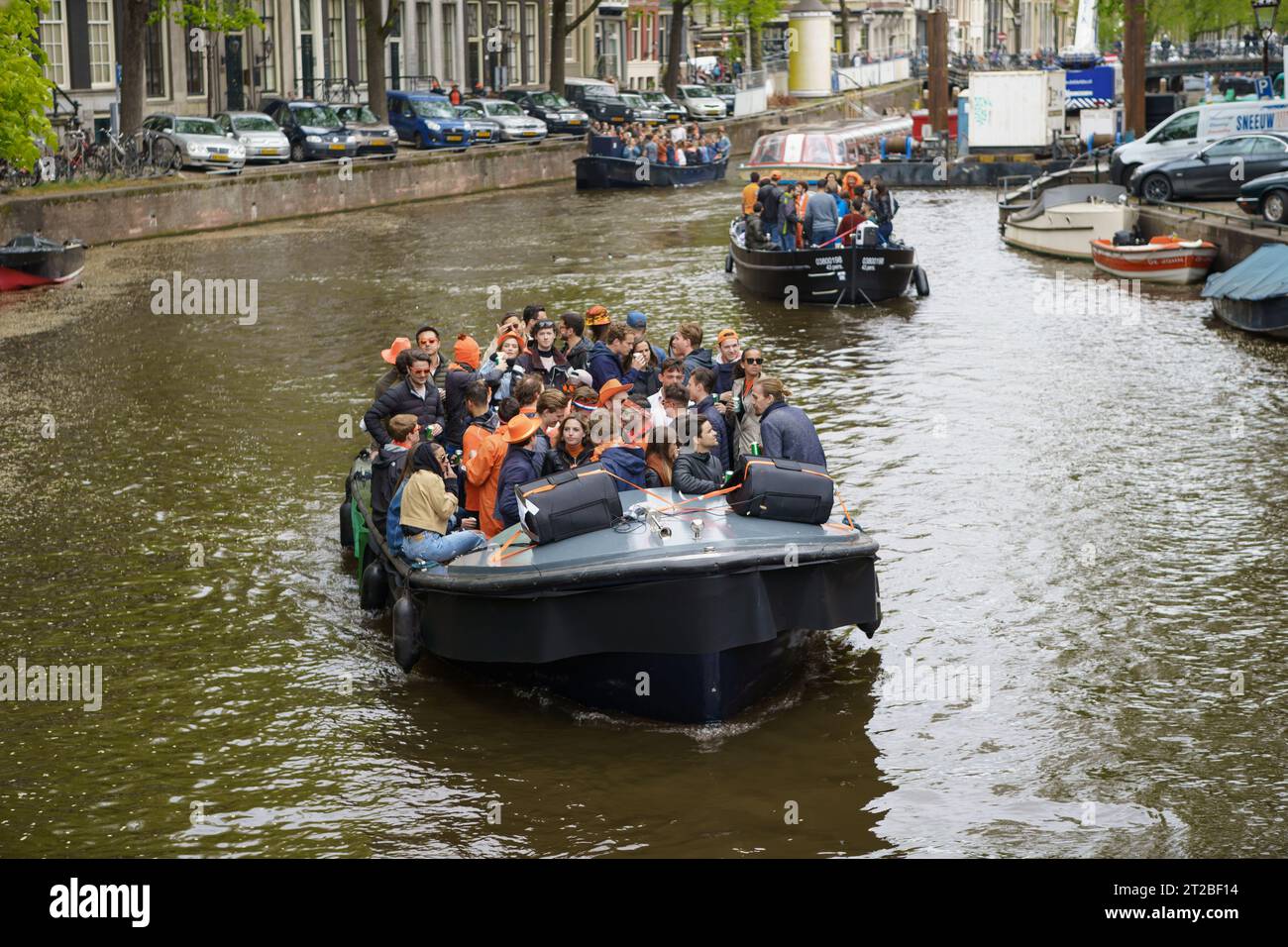 Group of people partying on a boat cruising in river Amstel on King's ...