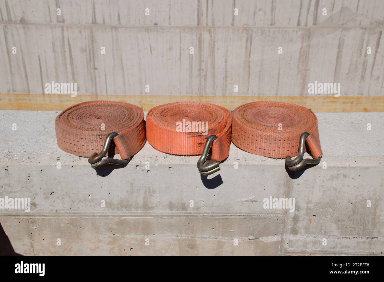 Straps for securing loads on a wall Stock Photo - Alamy
