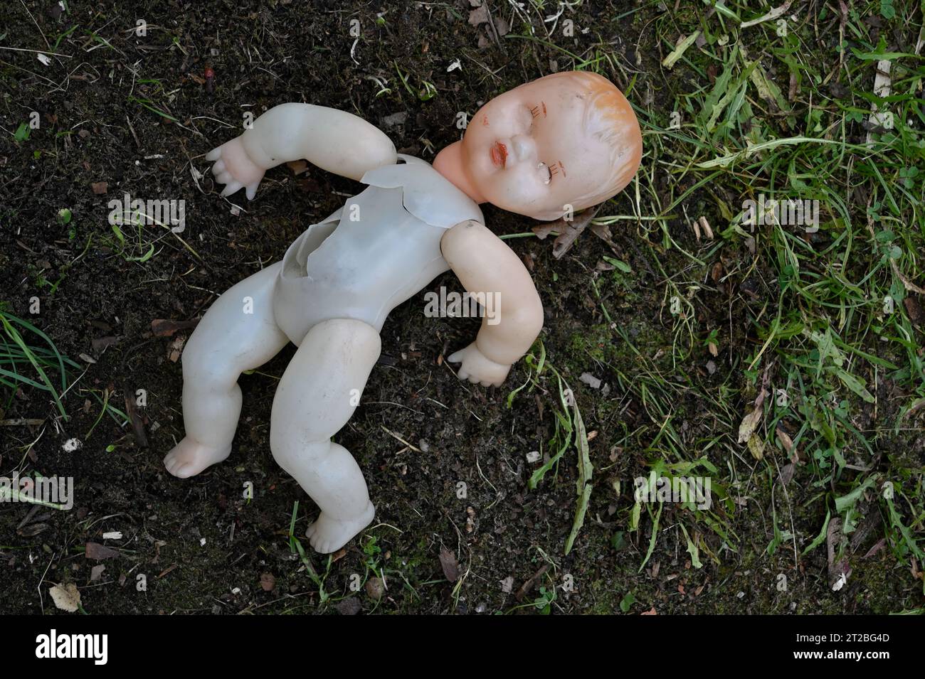 old broken plastic doll on the ground Stock Photo - Alamy