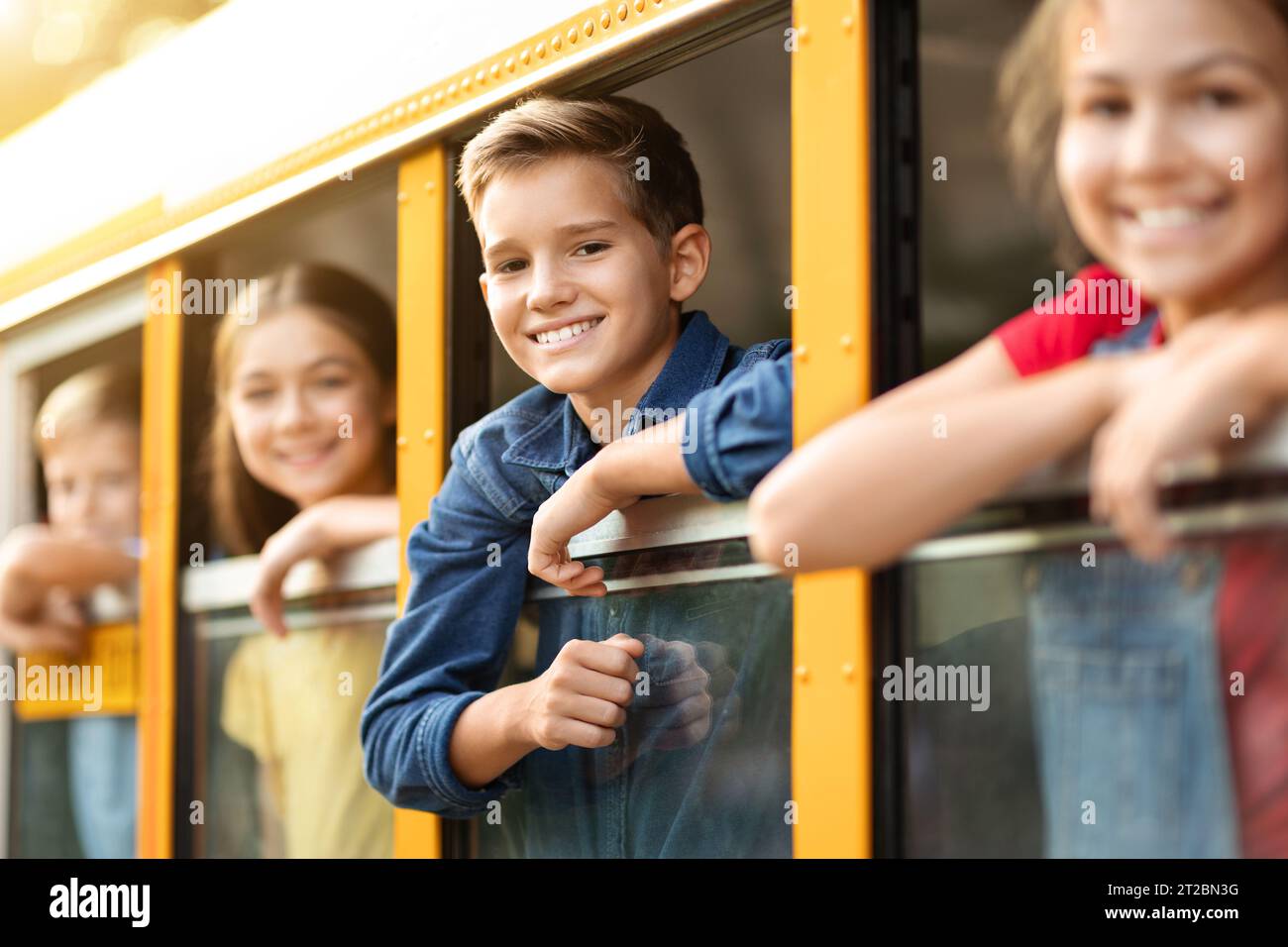 Excited children peeping from the school bus window Stock Photo - Alamy
