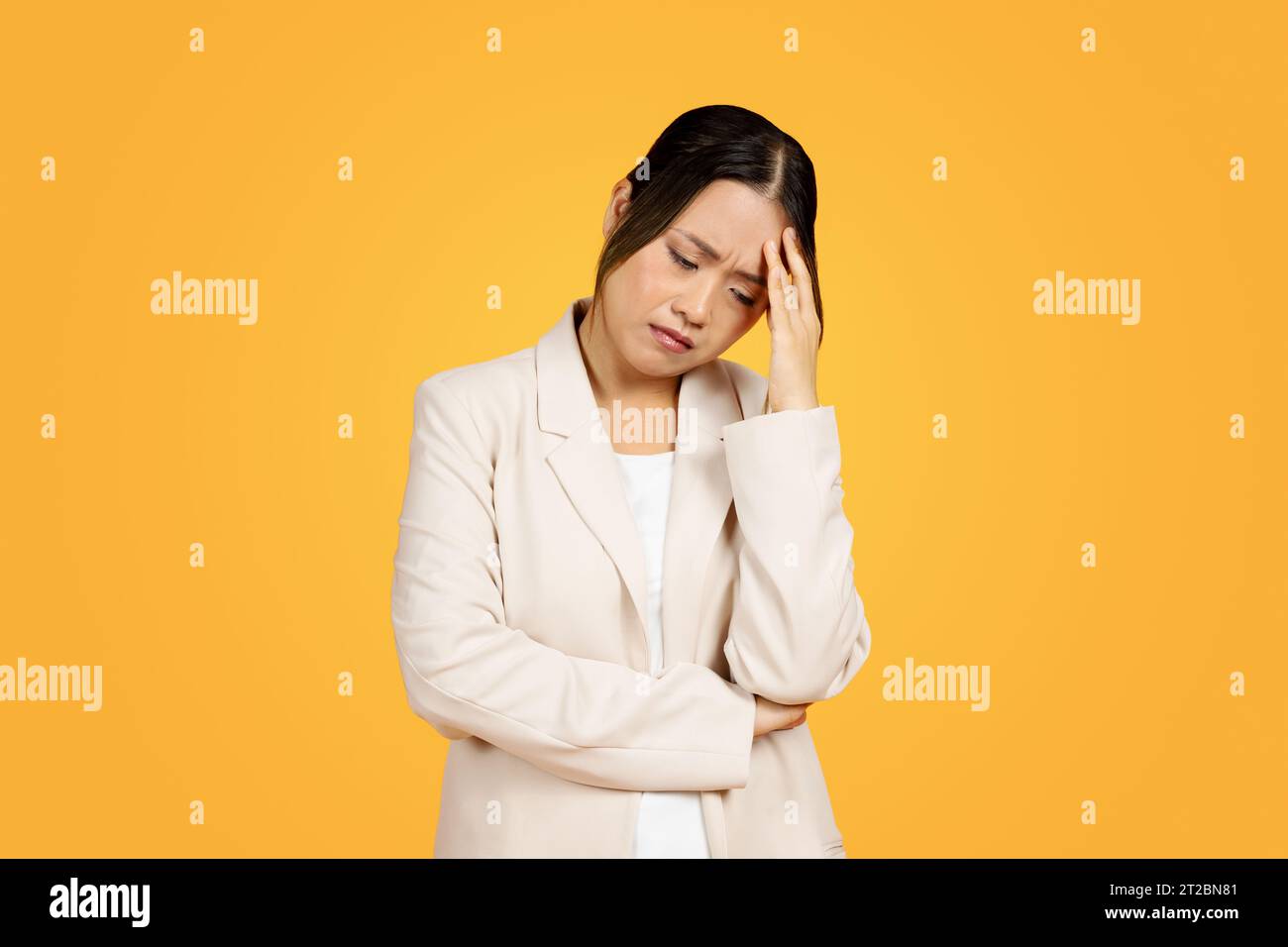 Unhappy asian young woman, with pained expression, clutching forehead ...