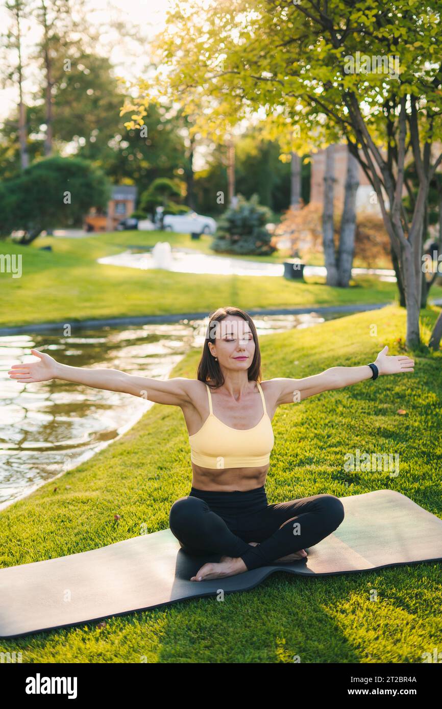 Beautiful caucasian fit woman doing breathing yoga exercise in the ...
