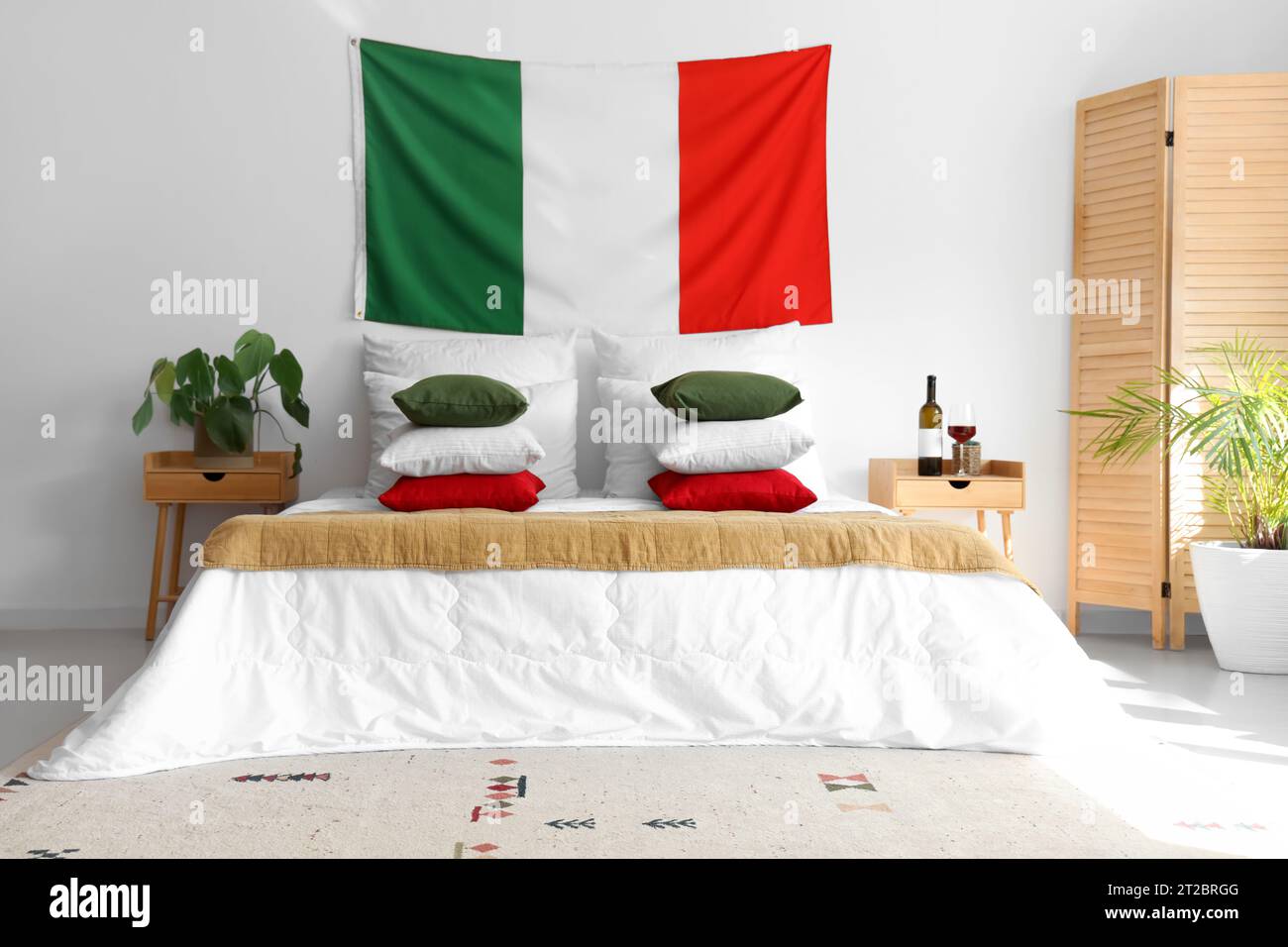 Interior of stylish bedroom with hanging Italian flag Stock Photo - Alamy