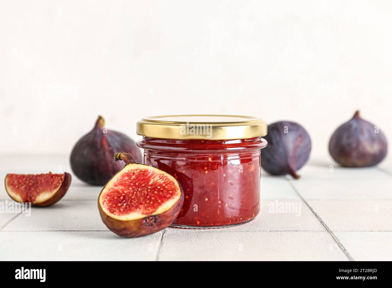 Jar of sweet fig jam on white tile table Stock Photo - Alamy