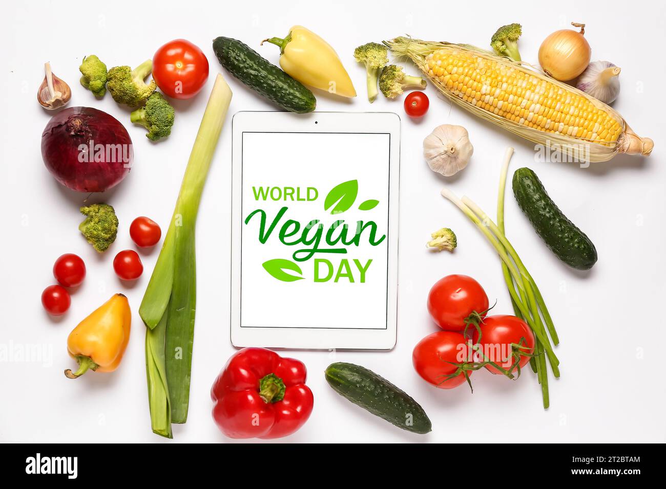 Tablet computer with text WORLD VEGAN DAY, fresh vegetables and fruits ...