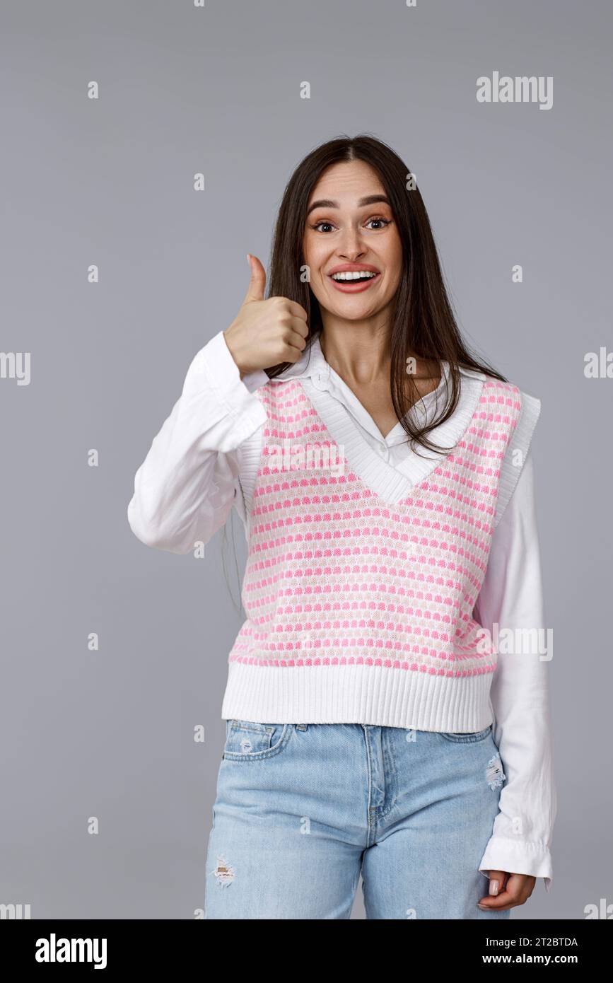 lovely ecstatic woman showing thumbs up gesture Stock Photo - Alamy