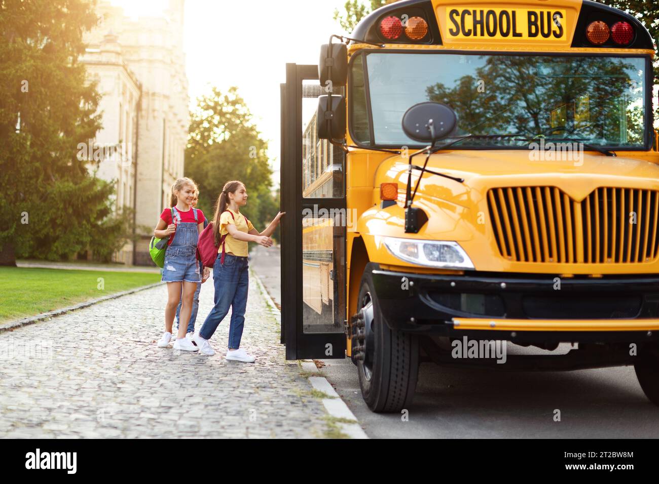 Group of happy kids boarding yellow school bus after lessons Stock ...